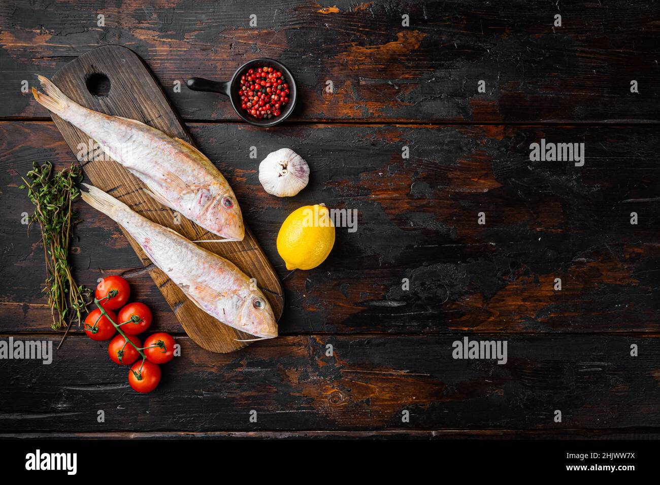 Raw Goatfish fresh whole fish set, with ingredients and herbs, on old ...