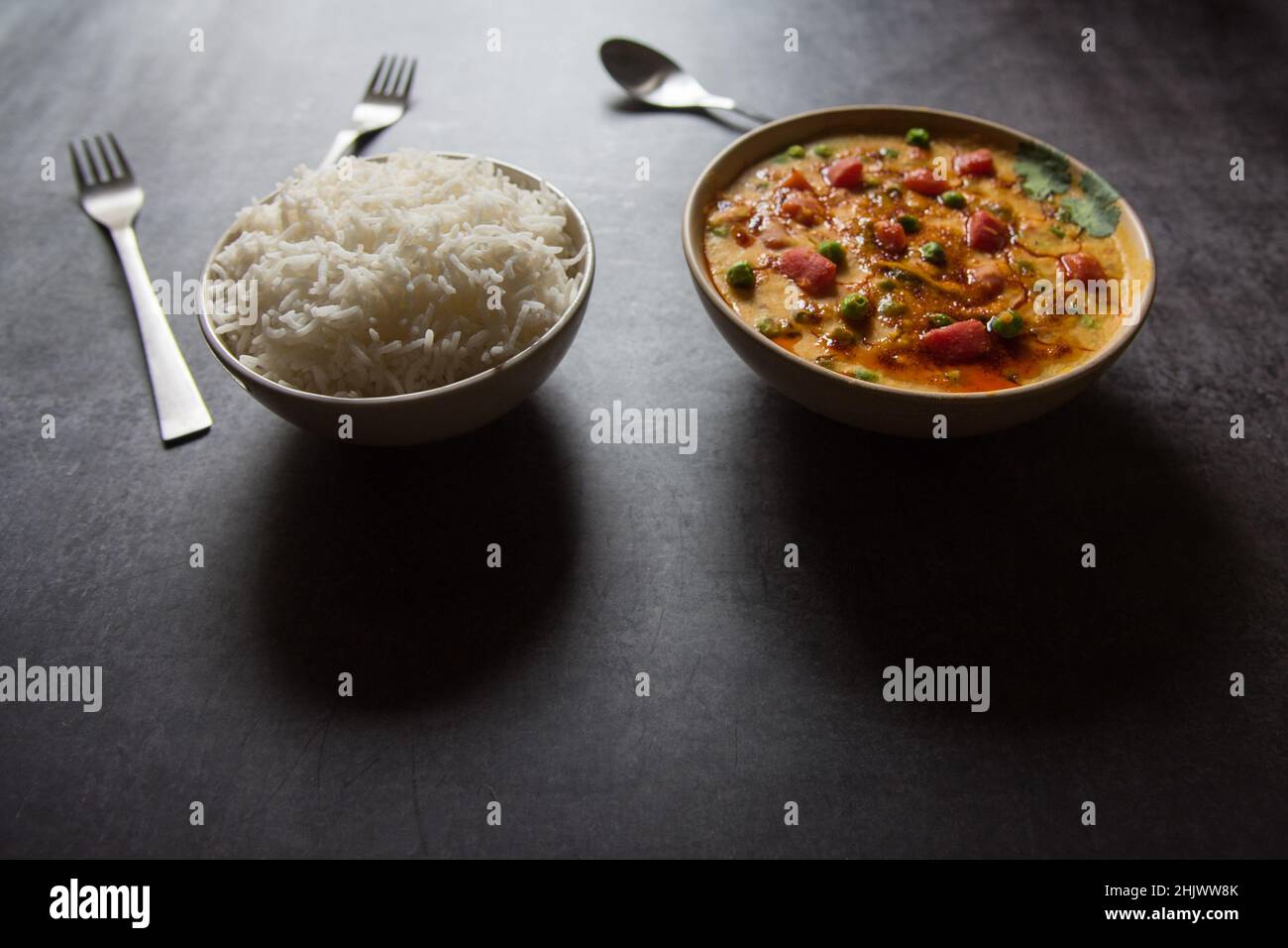 Indian lunch menu steamed rice and yellow dal or pulses on a background ...