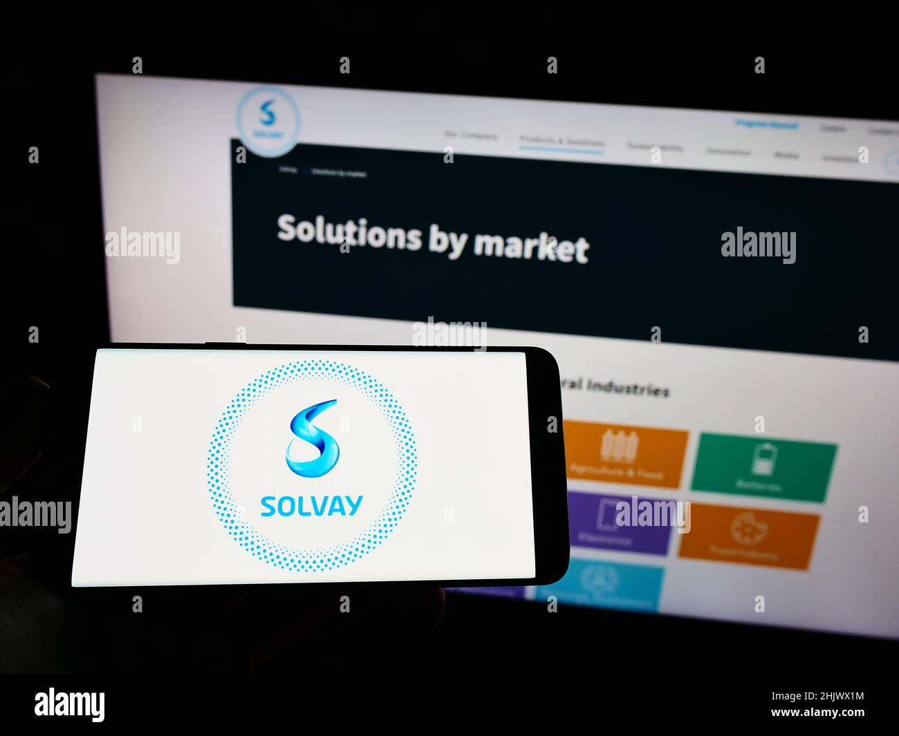 Person holding mobile phone with logo of Belgian chemical company ...