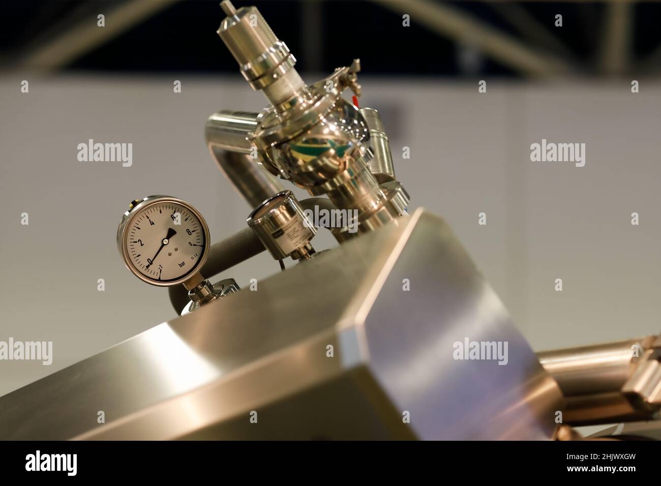 Pressure gauge on stainless steel equipment in a food factory. Pressure ...