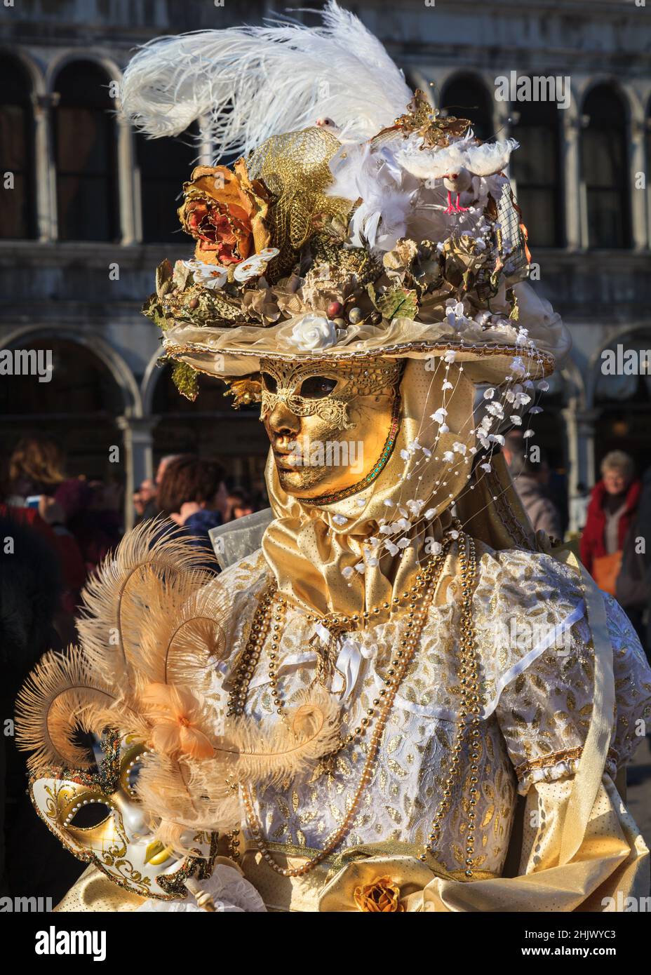 Woman in beautiful golden historic costume fancy dress gown, posing at ...