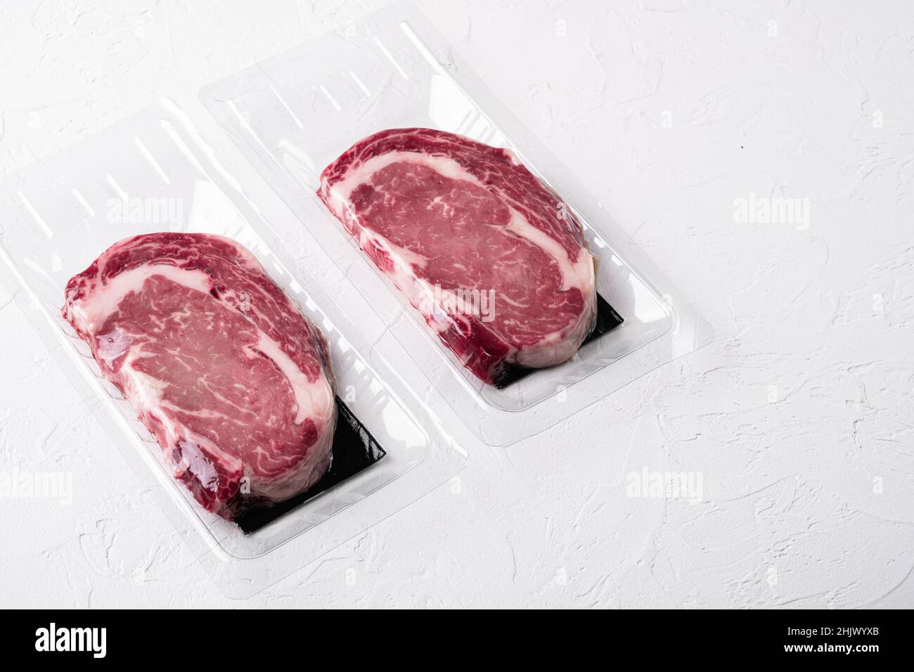 Steak, ribeye, vacuum packing set, on white stone table background ...