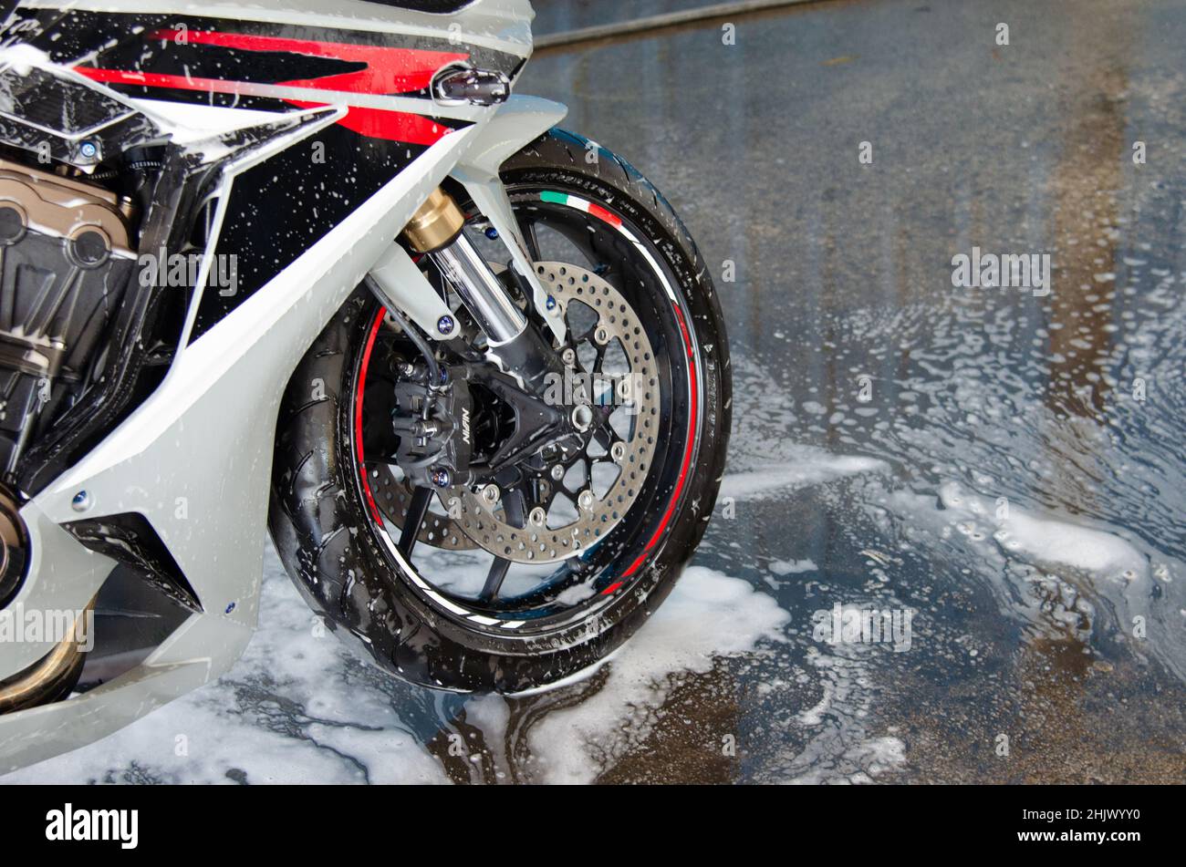 Cleaning the motorbike at the car wash shop Stock Photo - Alamy