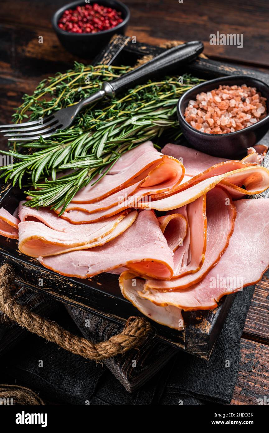 Italian Prosciutto cotto Ham slices in wooden tray with thyme and ...