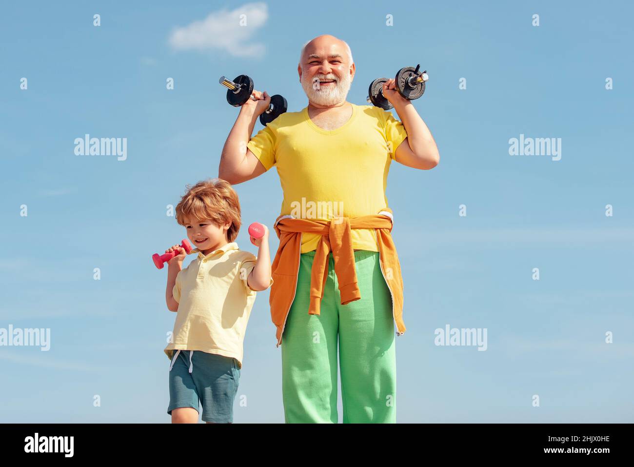Grandfather and son doing exercises. Active family enjoy sport and ...