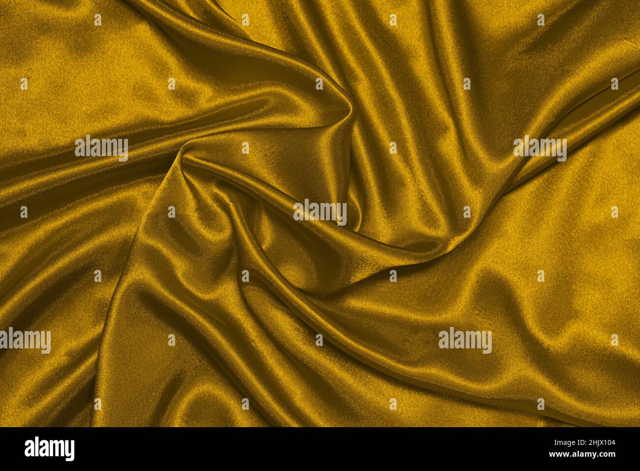 The texture of the satin fabric of mustard color, patterns of wrinkled ...