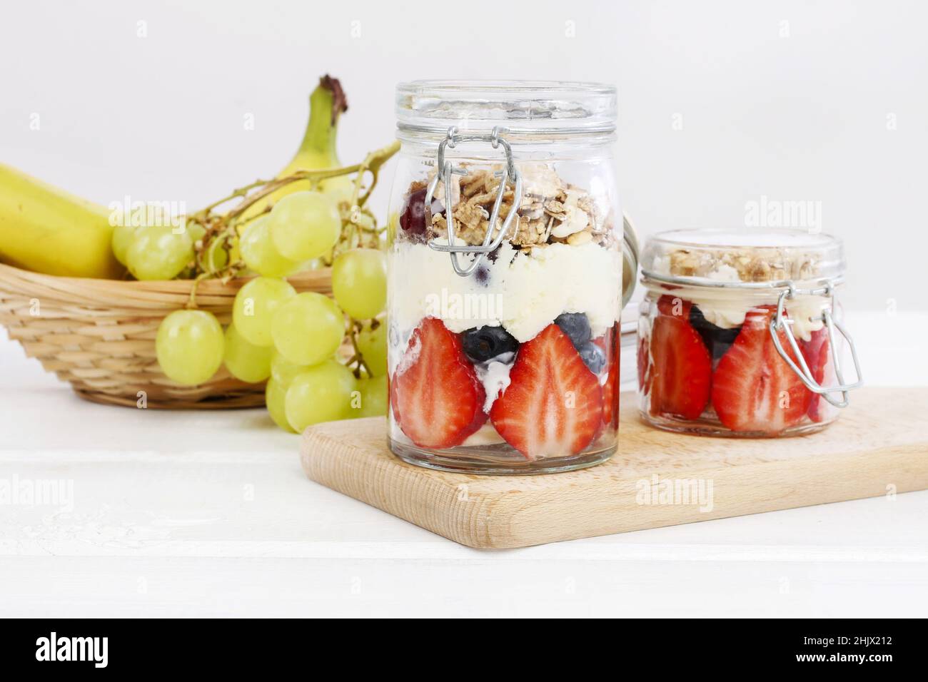 Layer fruit dessert in glass container. Summer party Stock Photo - Alamy