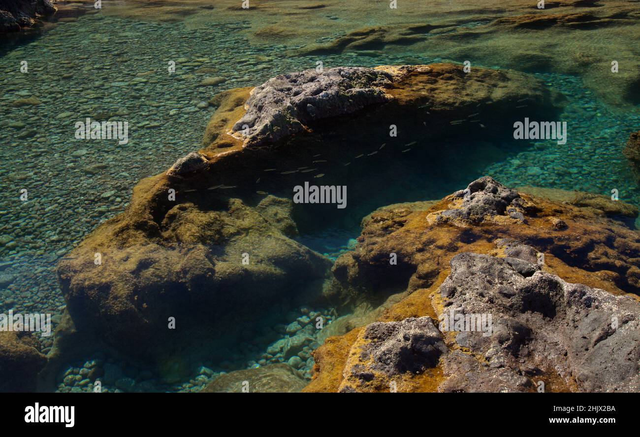 Gran Canaria, calm rock pools under steep cliffs of the north coast are ...
