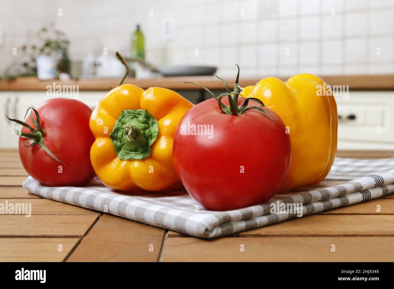 Peppers, courgettes and other vegetables lying on the table in a modern ...