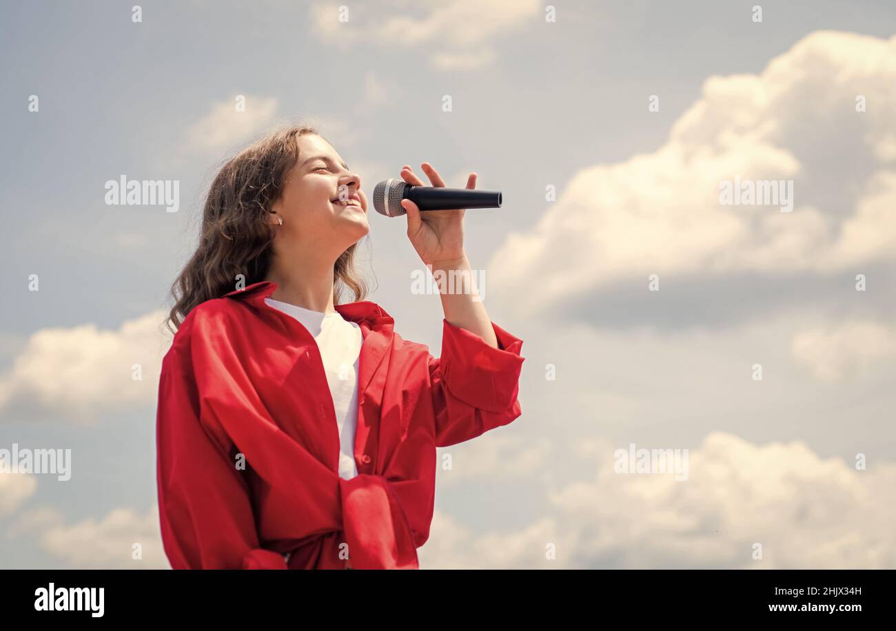Cute and stylish. having a party. Happy kid with microphone. Singing ...