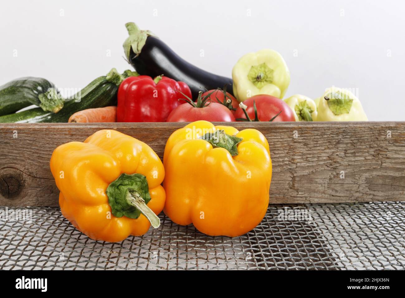Peppers, courgettes and other vegetables lying on the table in a modern ...