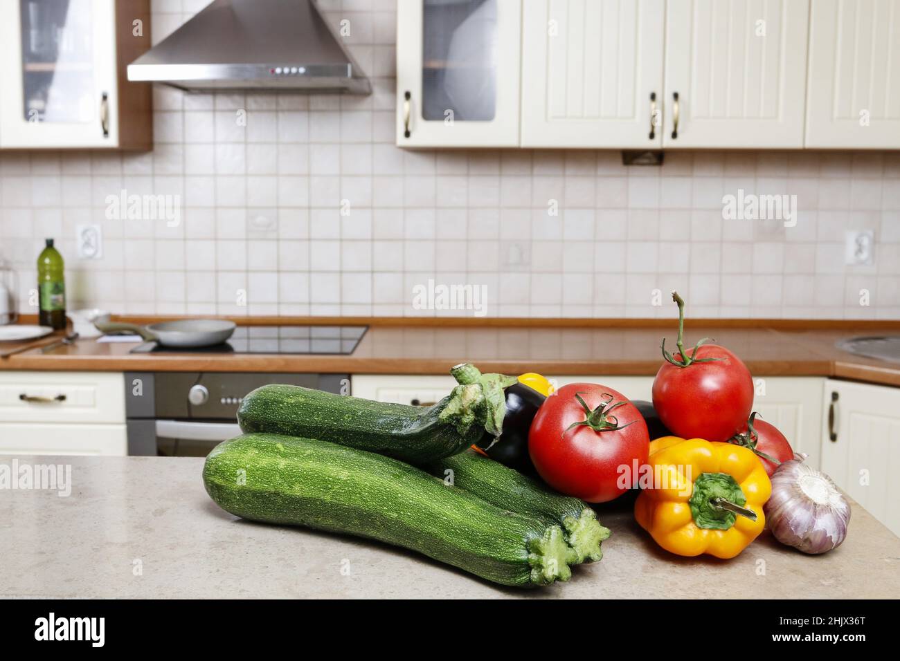 Peppers, courgettes and other vegetables lying on the table in a modern ...