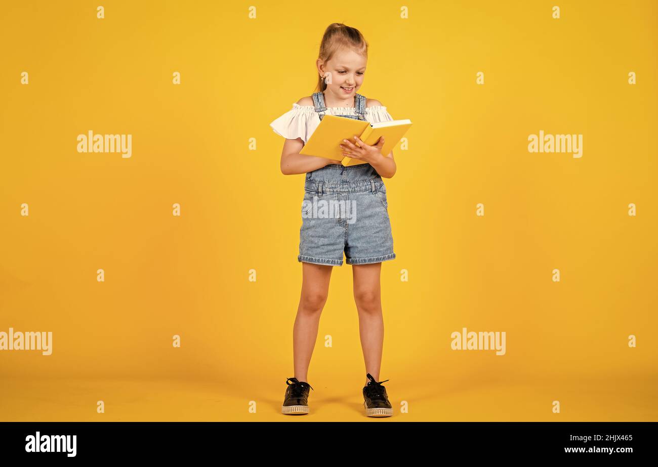 cute kid going to read information from book, back to school Stock ...