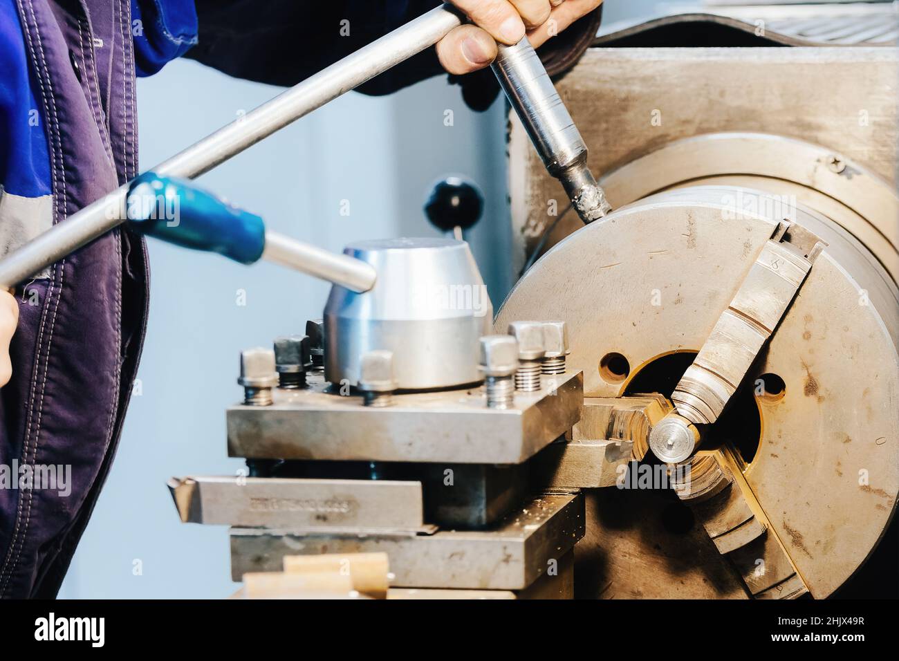 Turner hands and lathe close-up. metal turner works at workplace in ...