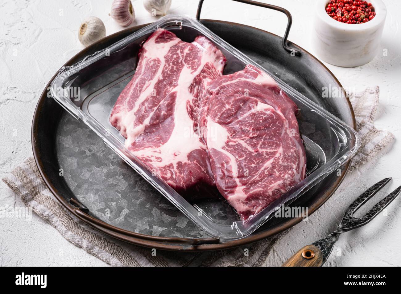 Chuck Eye Roll in a packaging tray set, on white stone table background ...