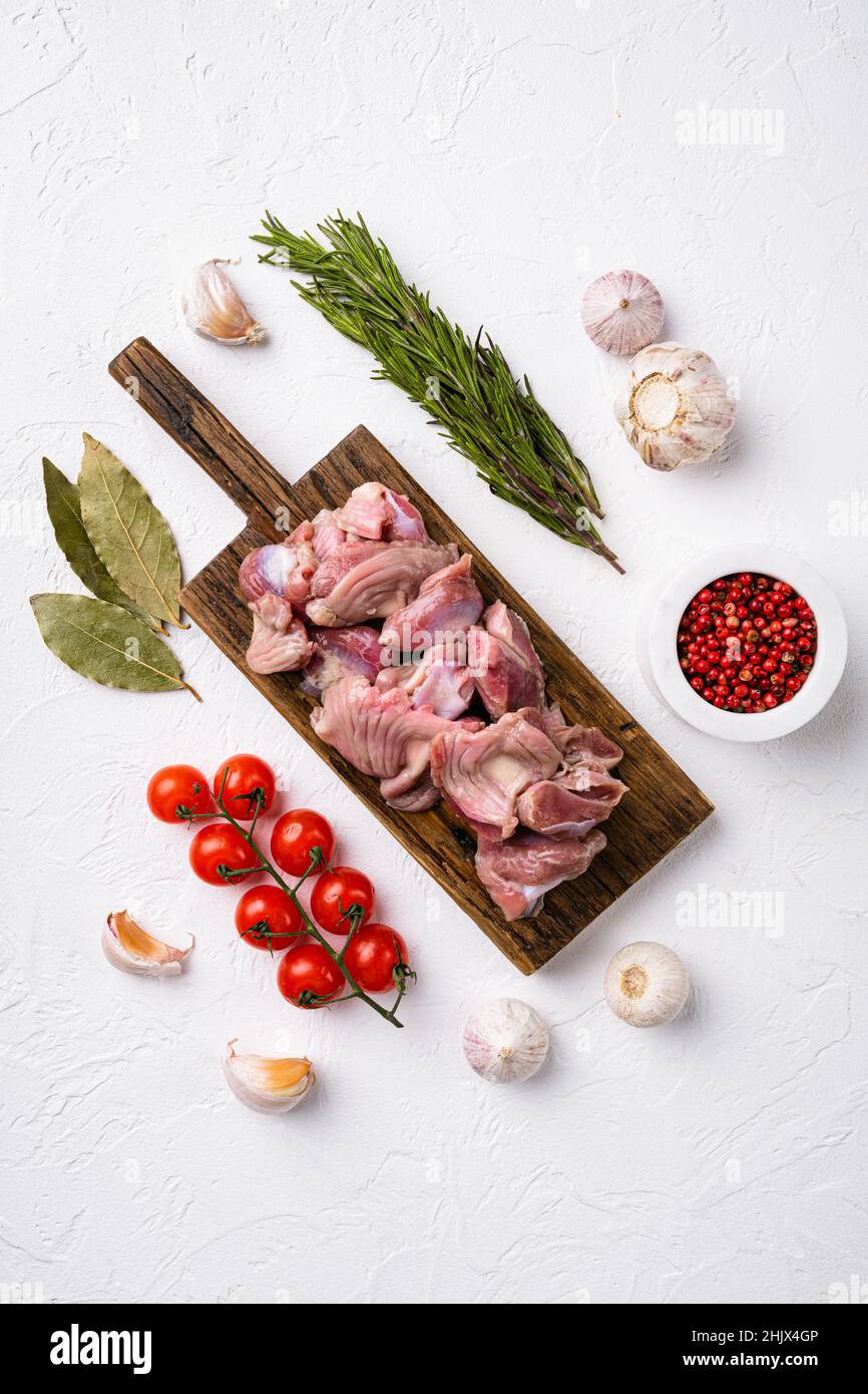 Fresh Bird chicken giblets gizzards, stomachs set, on white stone table ...
