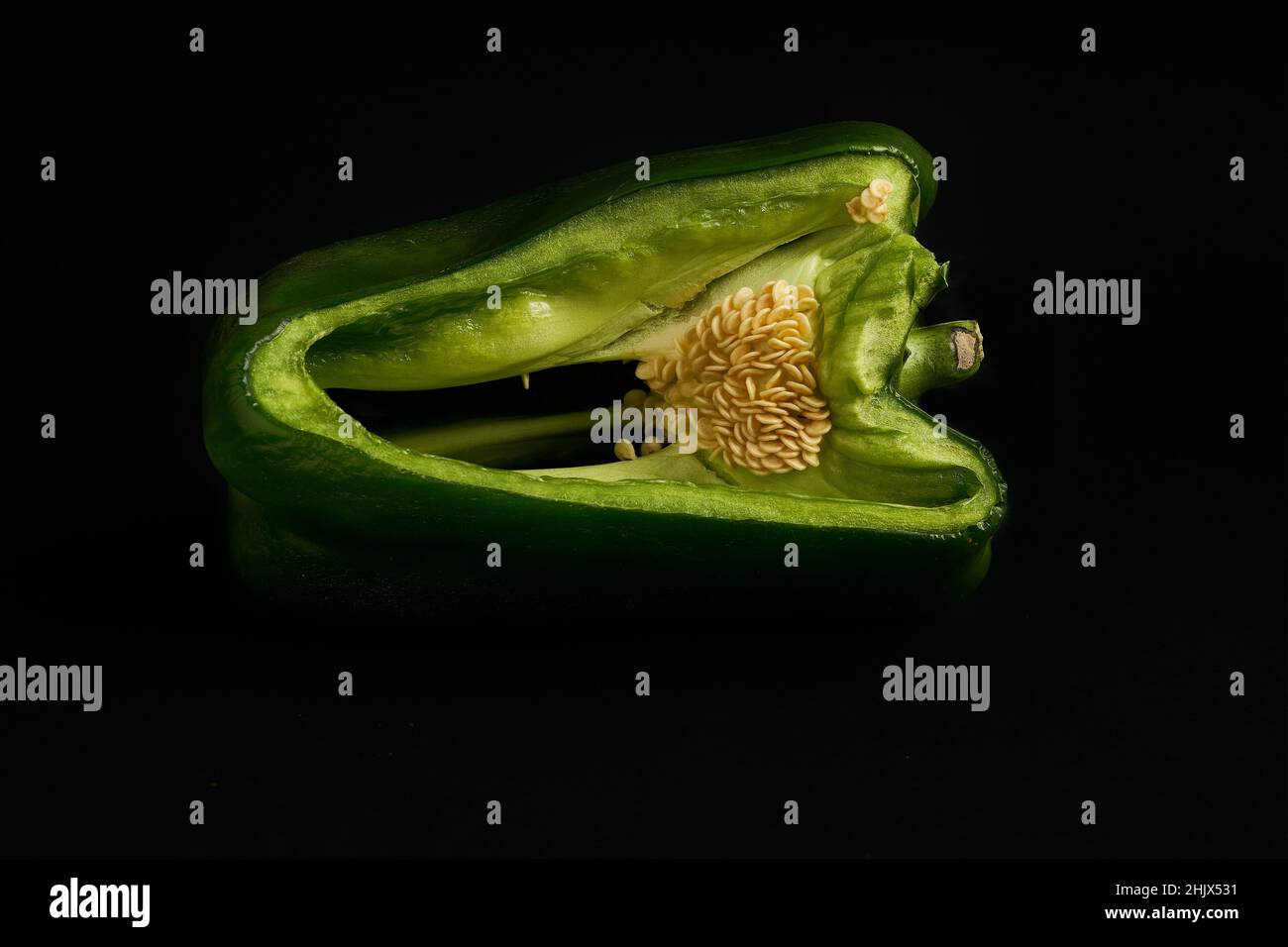 Closeup of the cut bell pepper isolated on black background Stock Photo ...