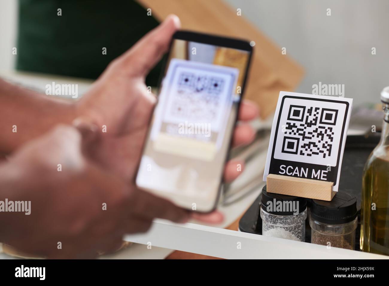 Close-up image of customer scanning qr code on counter before making ...