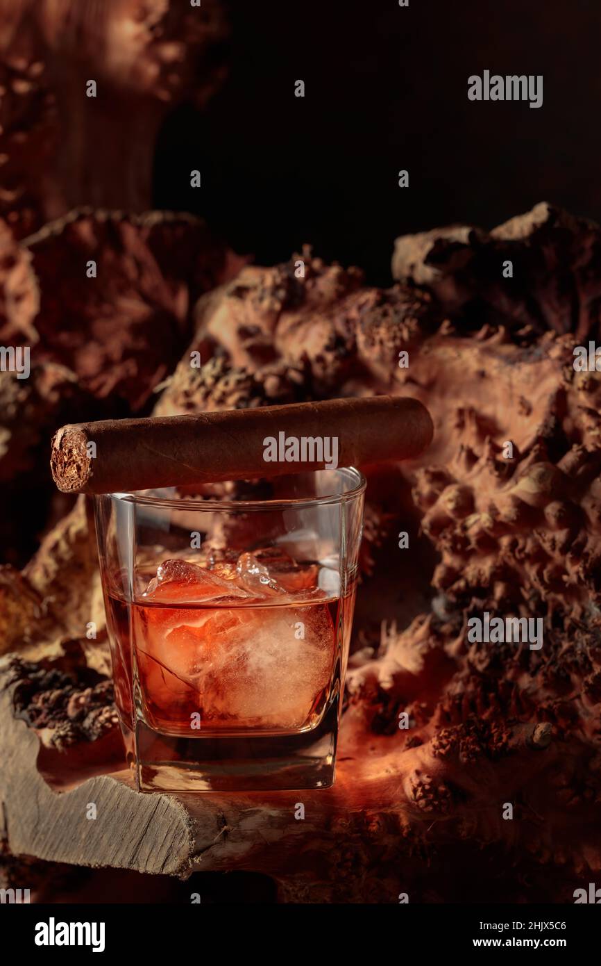 Whiskey wit ice and cigar on an old dried stump. Copy space Stock Photo ...
