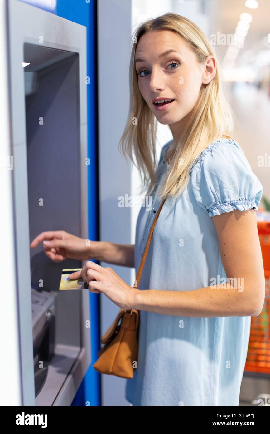 Taking money from cash machine hi-res stock photography and images - Alamy