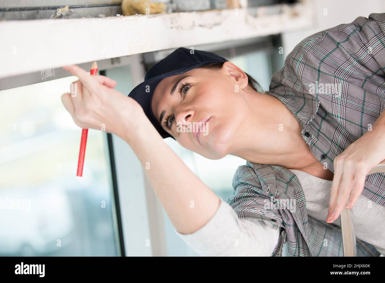 worker preparing window for shutter installation Stock Photo - Alamy