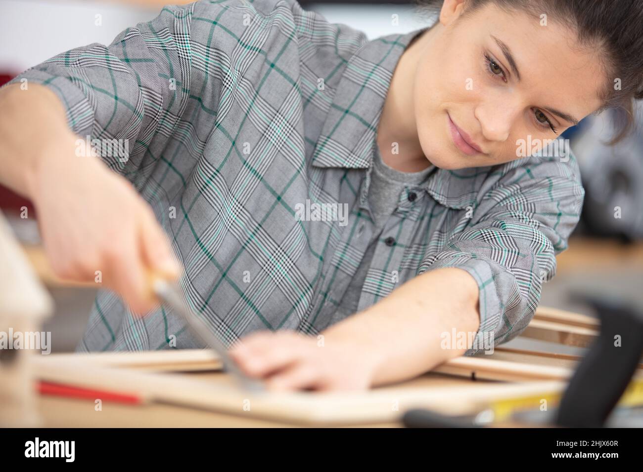 female carpenter using tools in workshop Stock Photo - Alamy