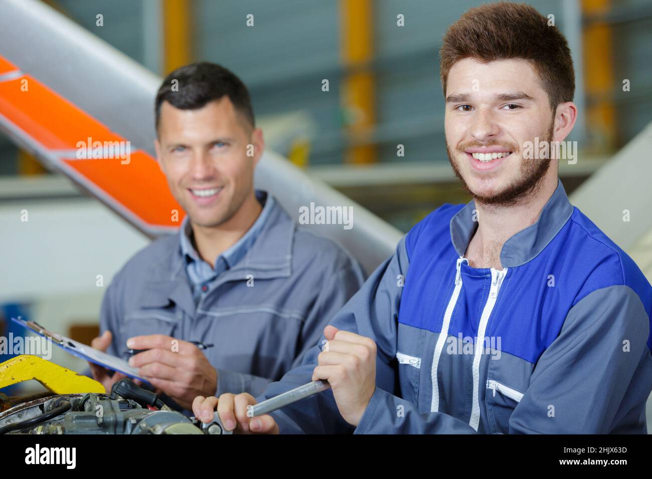 two men working on a machine Stock Photo - Alamy