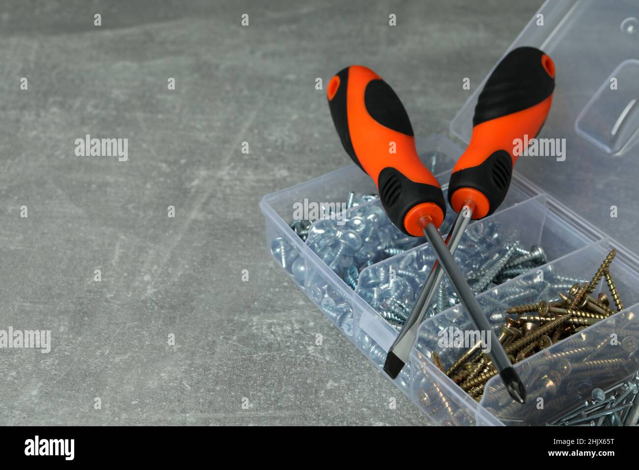 Box with screws and screwdrivers on gray textured background Stock ...