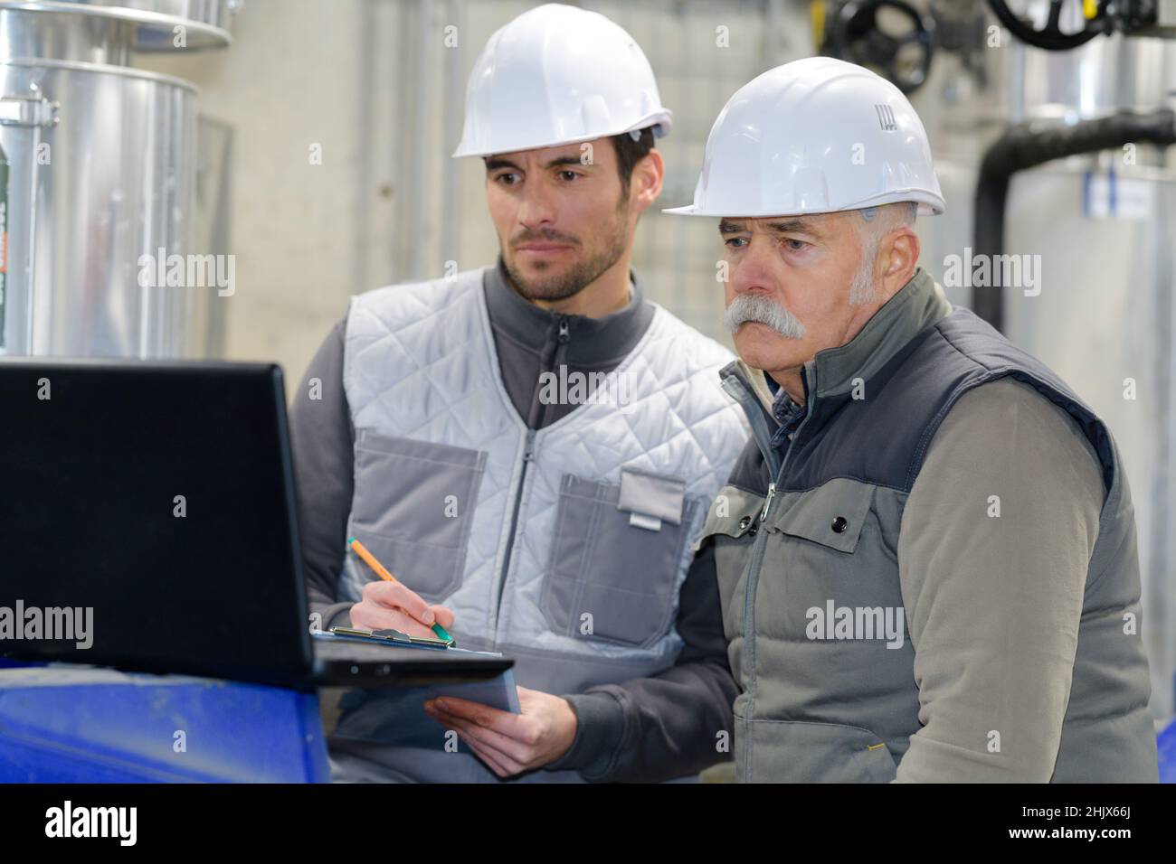 distillery supervision workers looking at the computer Stock Photo - Alamy