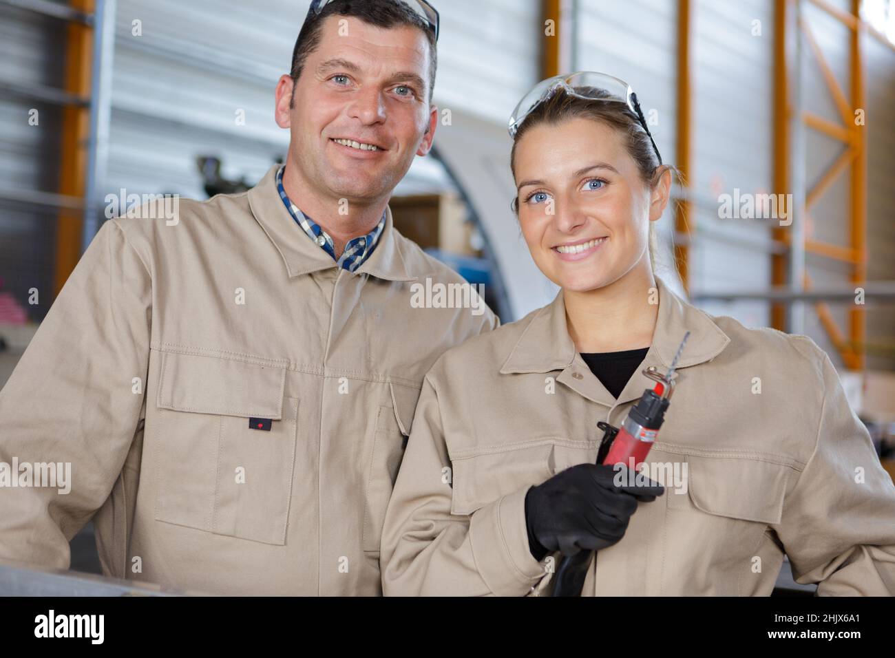 two factory workers are posing Stock Photo - Alamy