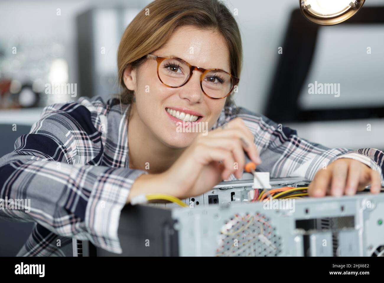 woman repairing computer with screwdriver Stock Photo - Alamy