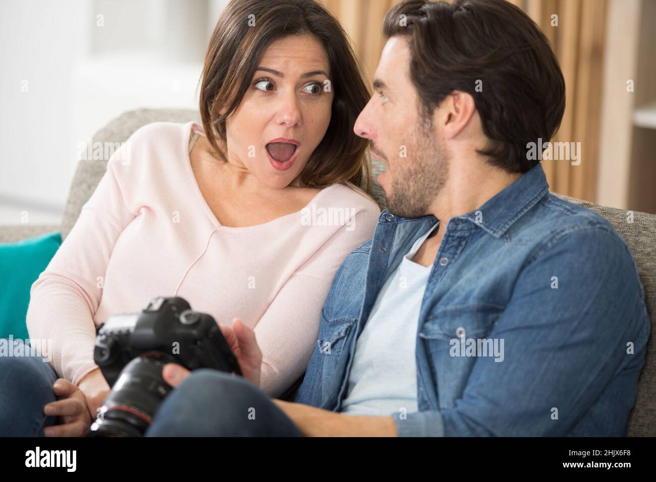 shocked couple looking at photos Stock Photo - Alamy