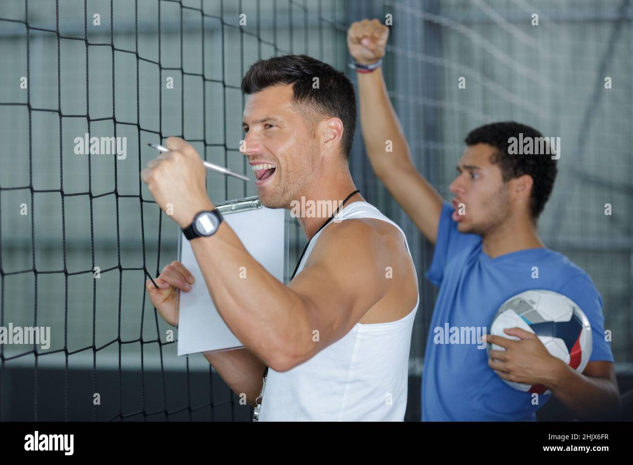 happy football coach and player Stock Photo - Alamy