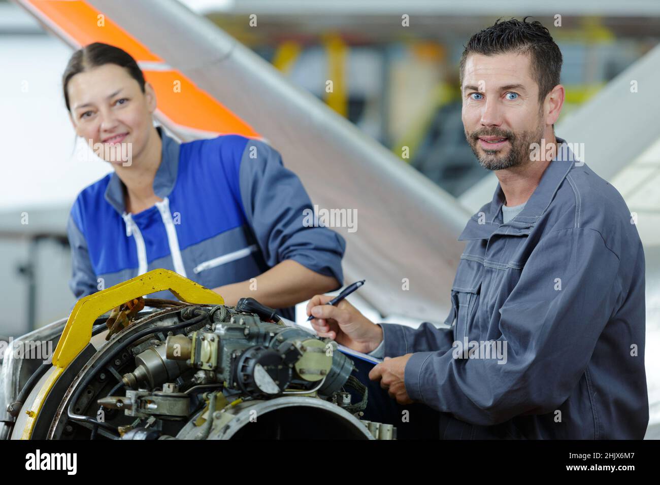 factory workers working with engine Stock Photo - Alamy