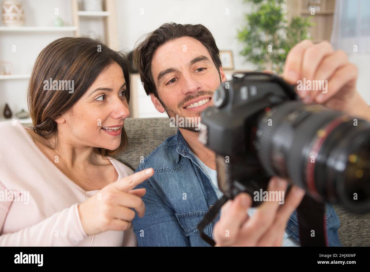 photographer and his wife man hold dslr camera Stock Photo - Alamy