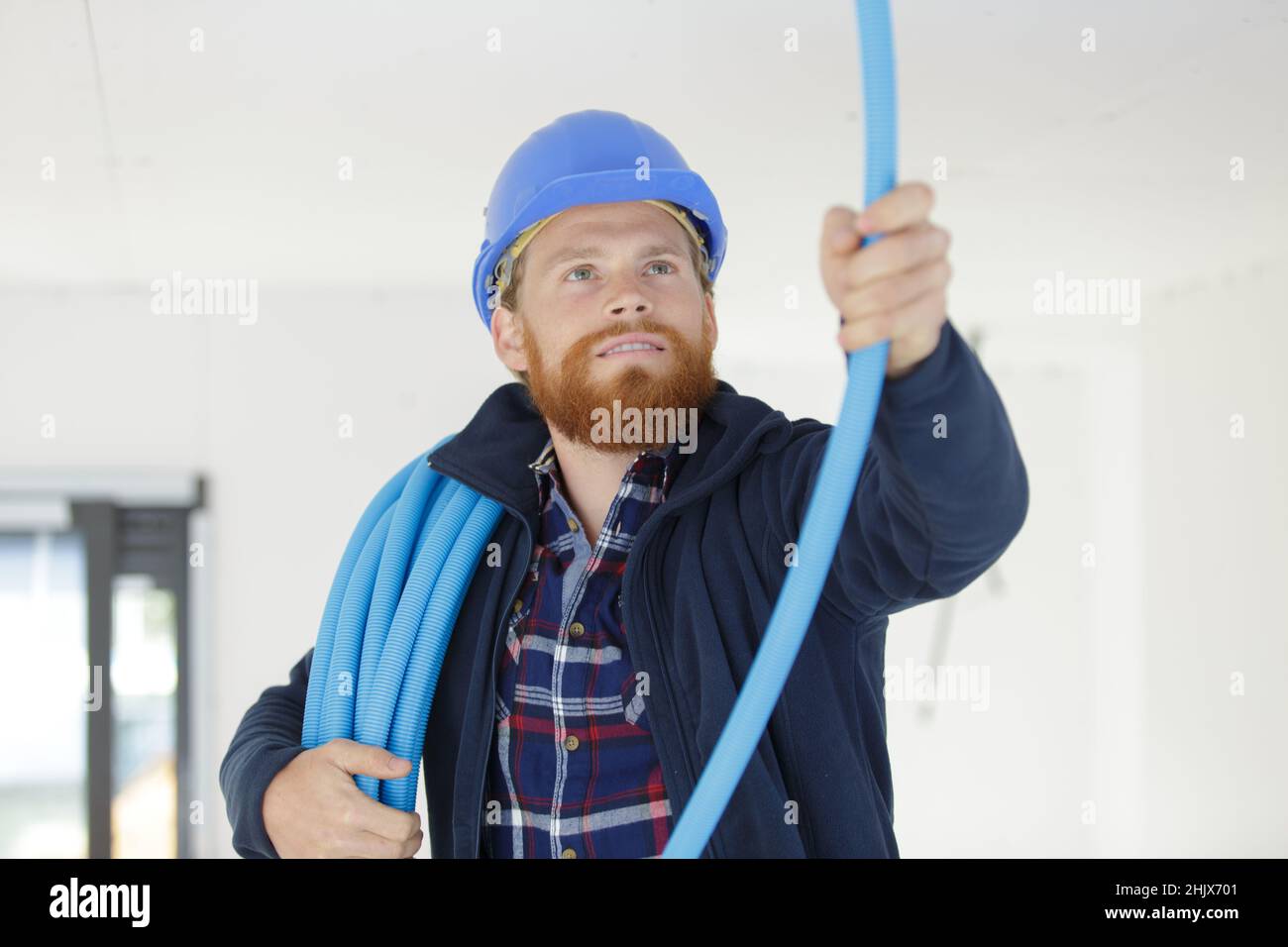 Portrait happy man holding pipe hi-res stock photography and images - Alamy