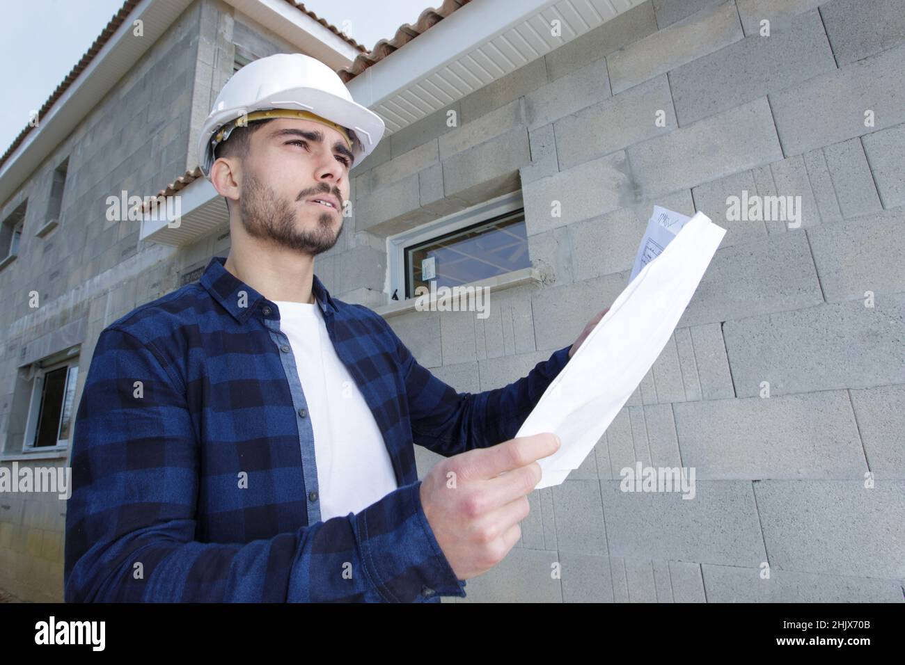 engineer using construction paper plans Stock Photo - Alamy