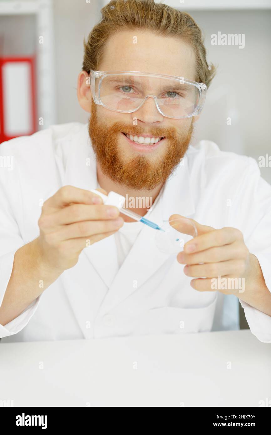 mature lab worker conducting a chemical experiment Stock Photo - Alamy