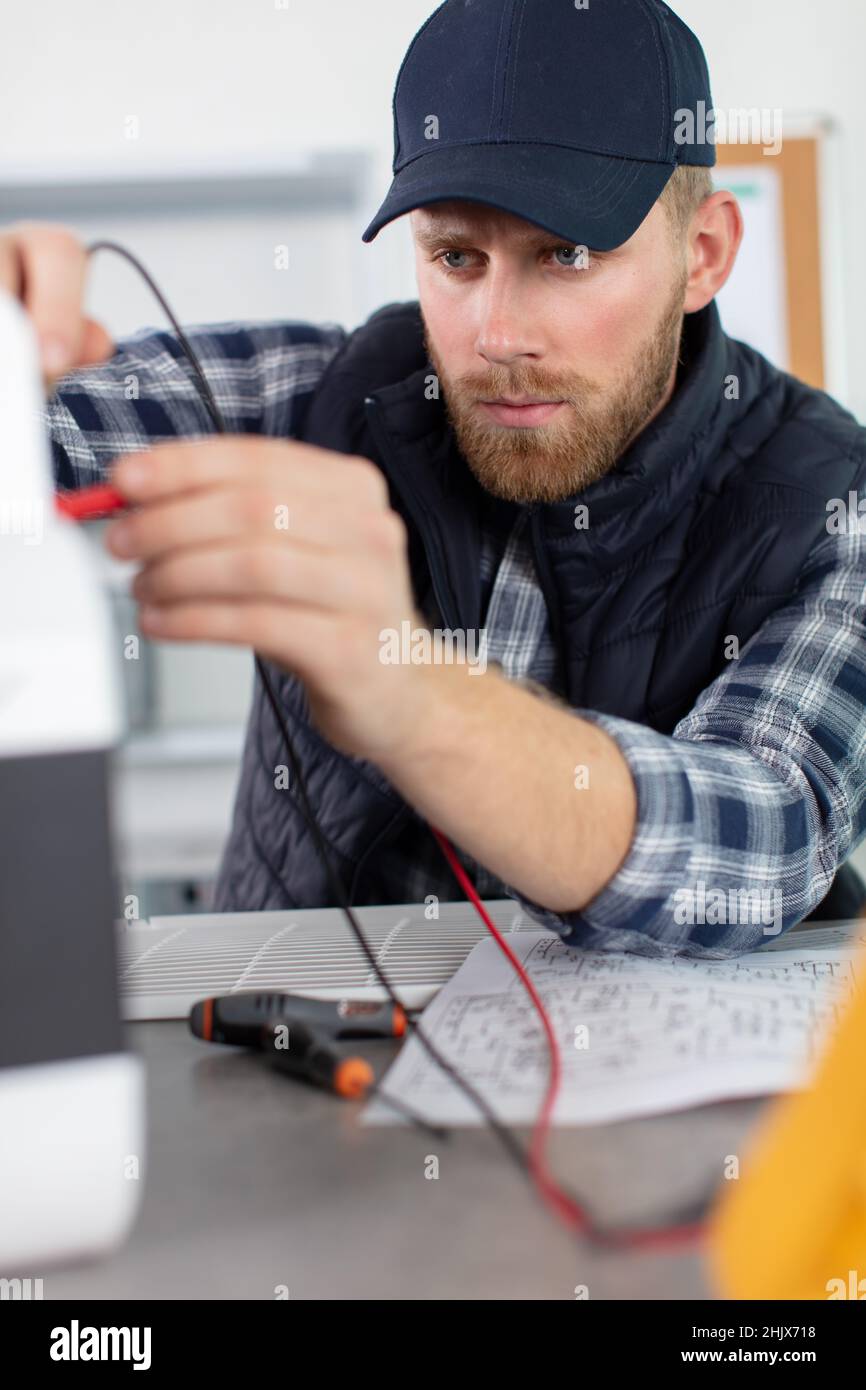 computer engineer working on broken console in his office Stock Photo ...