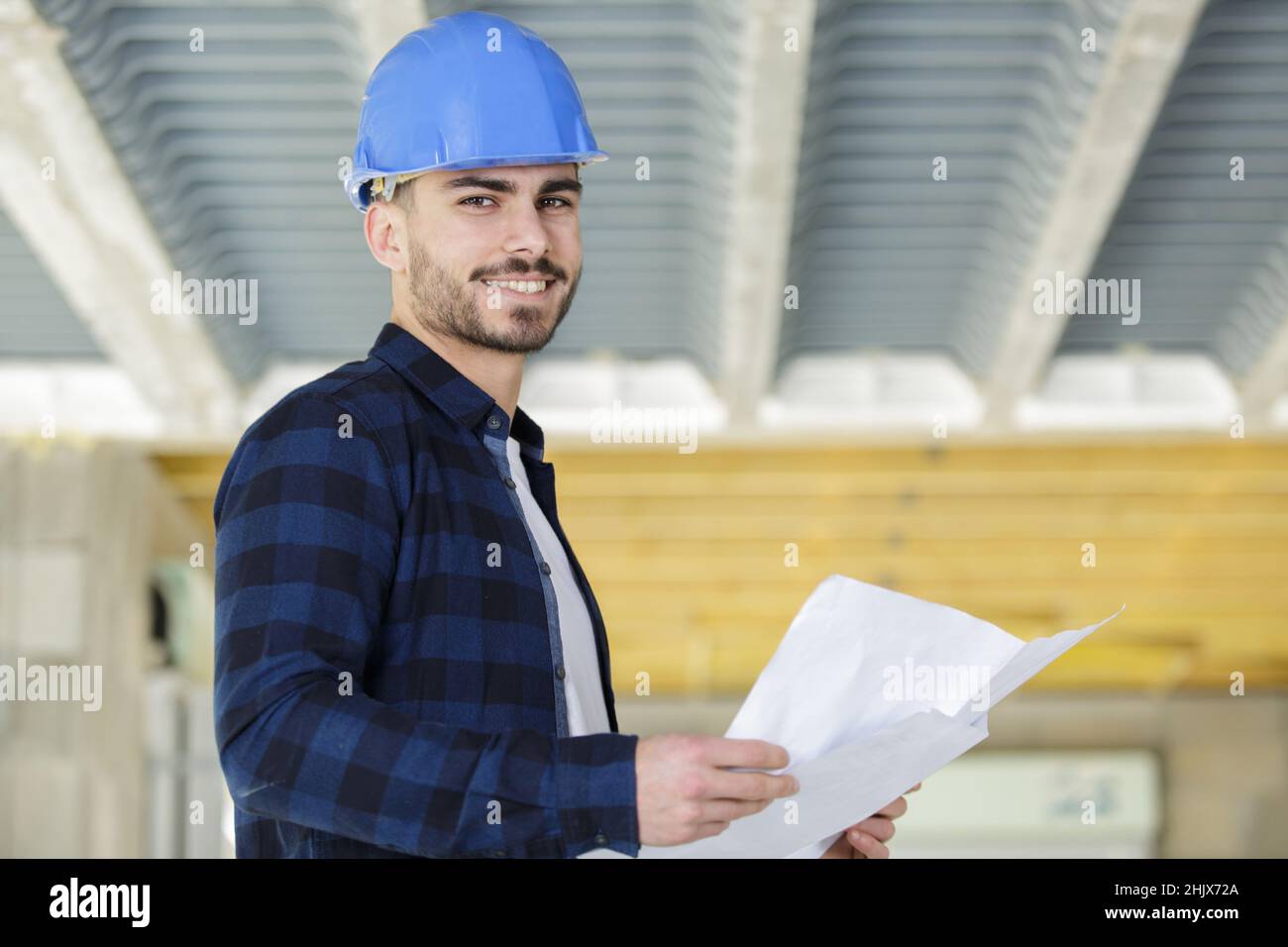 portrait of builder on site with plans Stock Photo - Alamy
