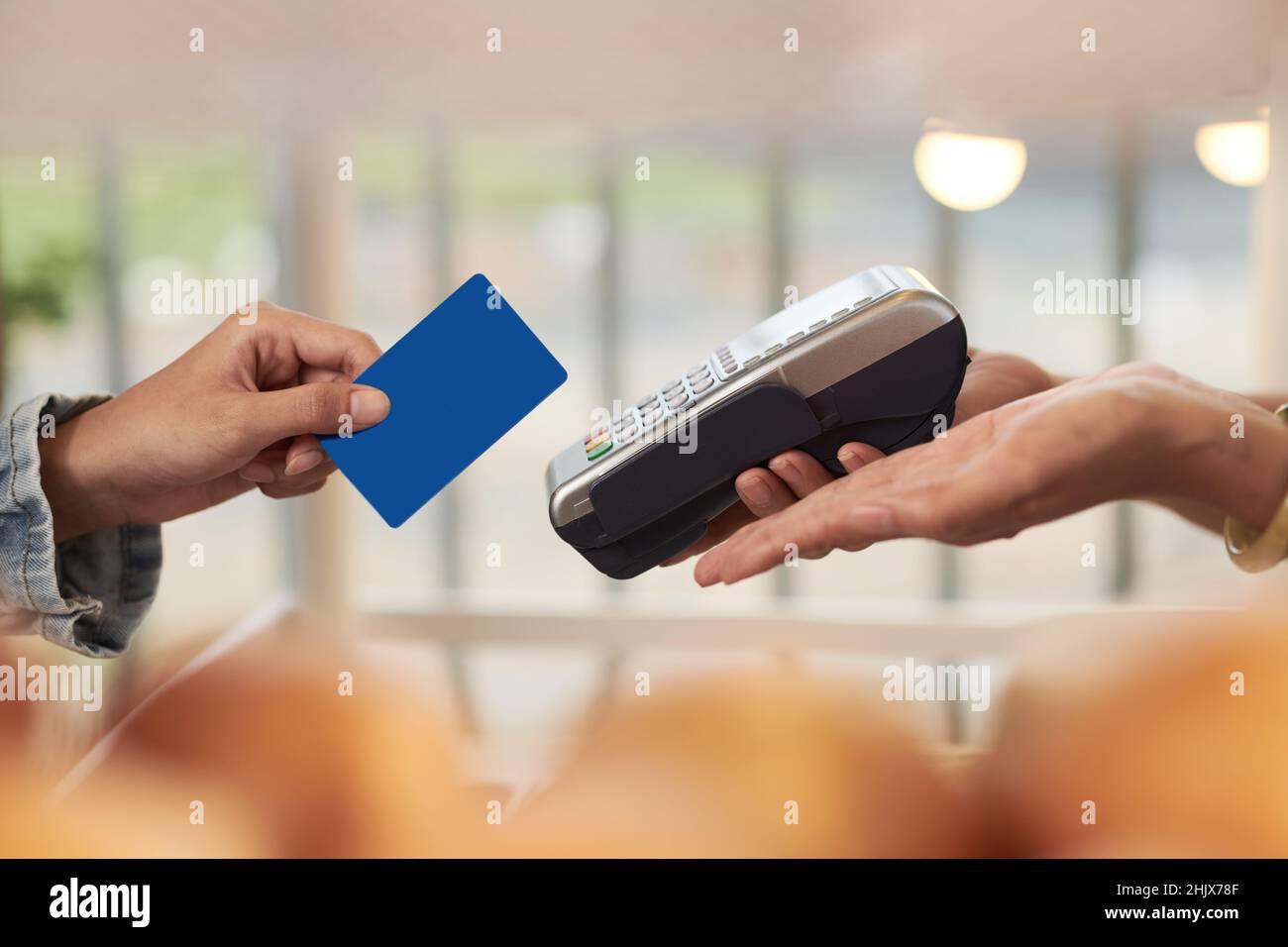 Hands of customer swiping credit card when paying for order at food ...