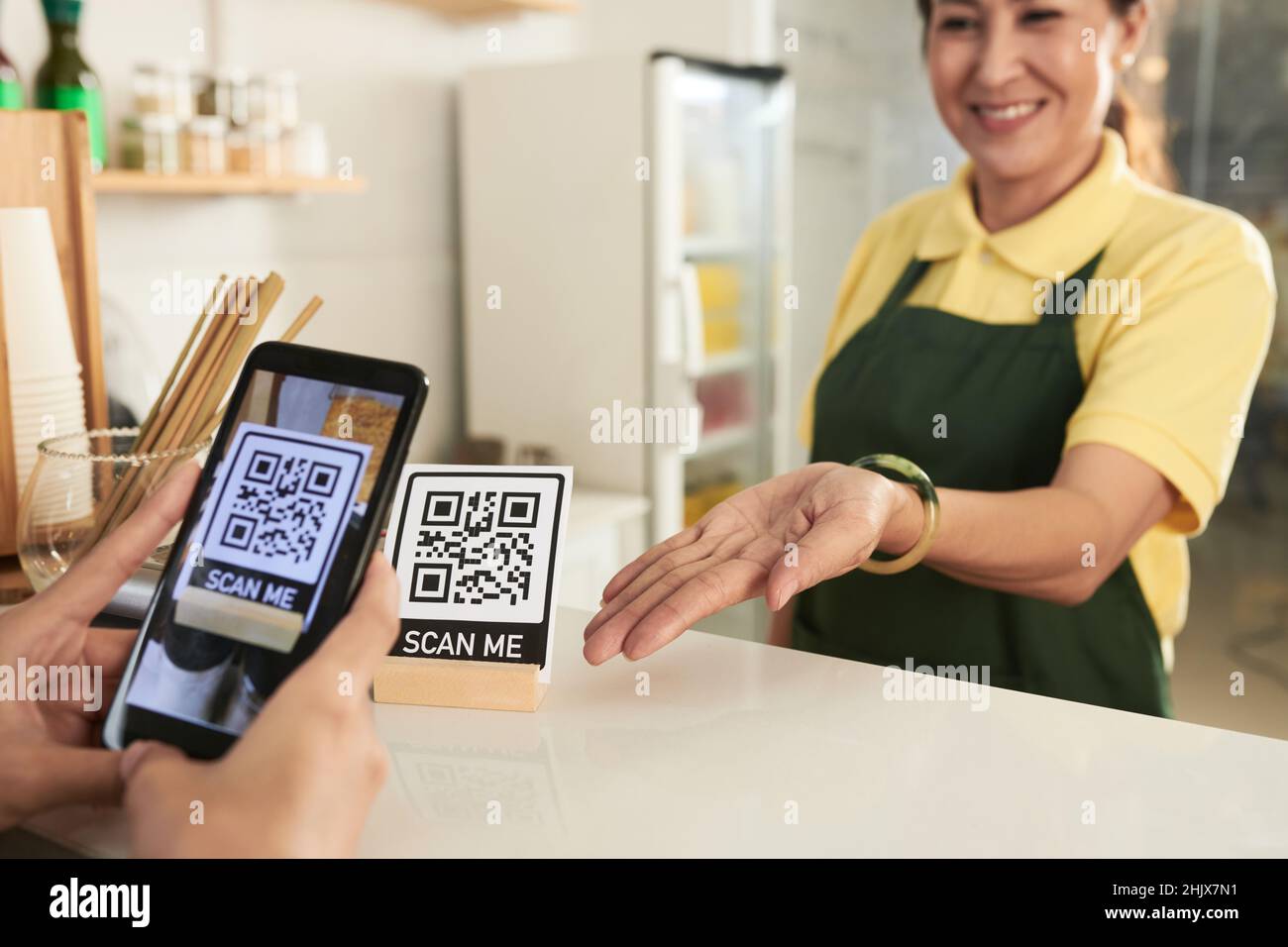 Closeup image of customer scanning QR code in cafe to downloadu Stock ...