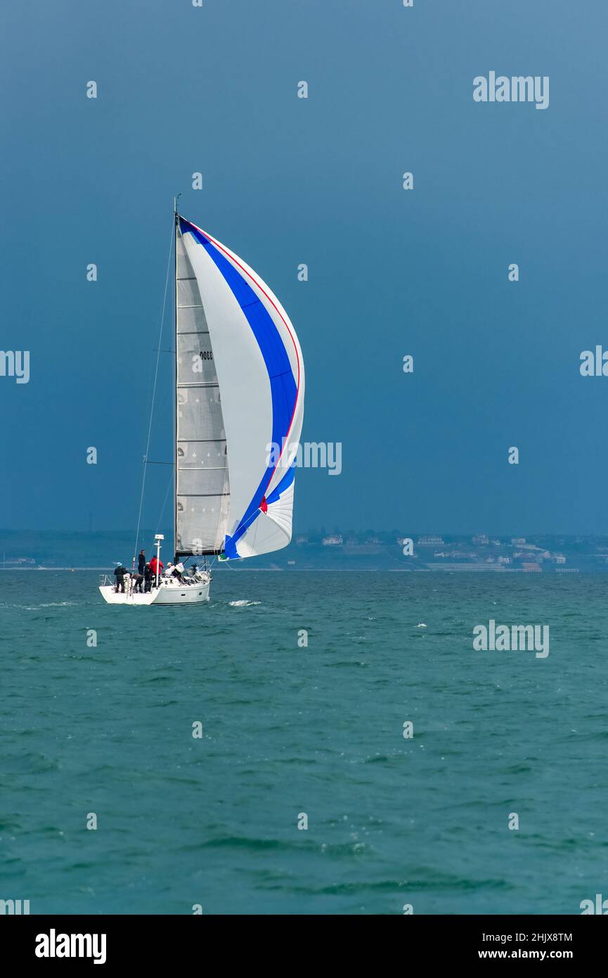 Sailboat on full sails sailing in the sea in a cloudy summer day before ...