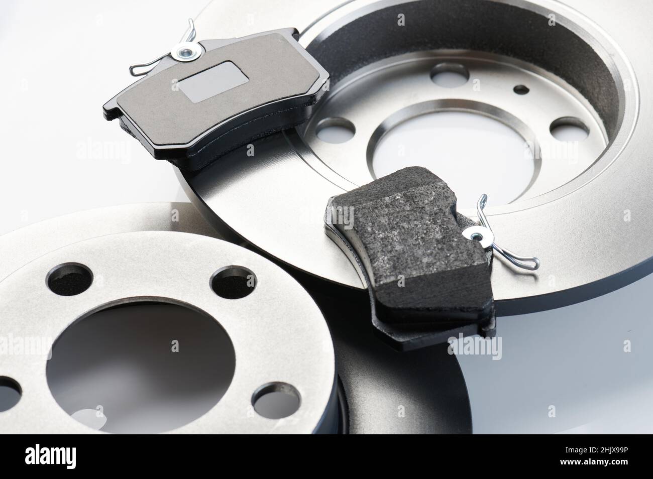 New metal car break disc and pads isolated on studio background Stock ...