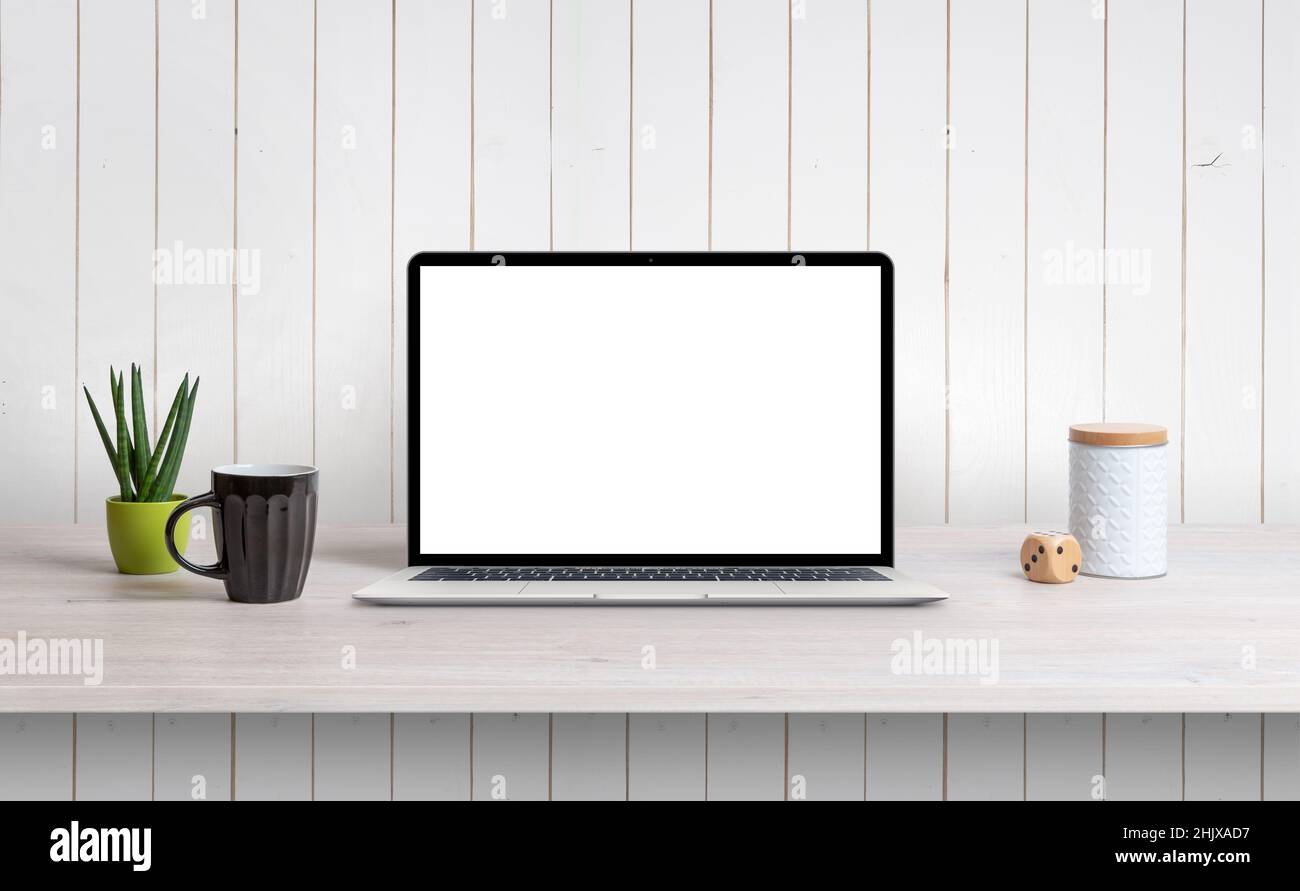 Lapop on desk with isolated white screen for mockup, app or web page ...