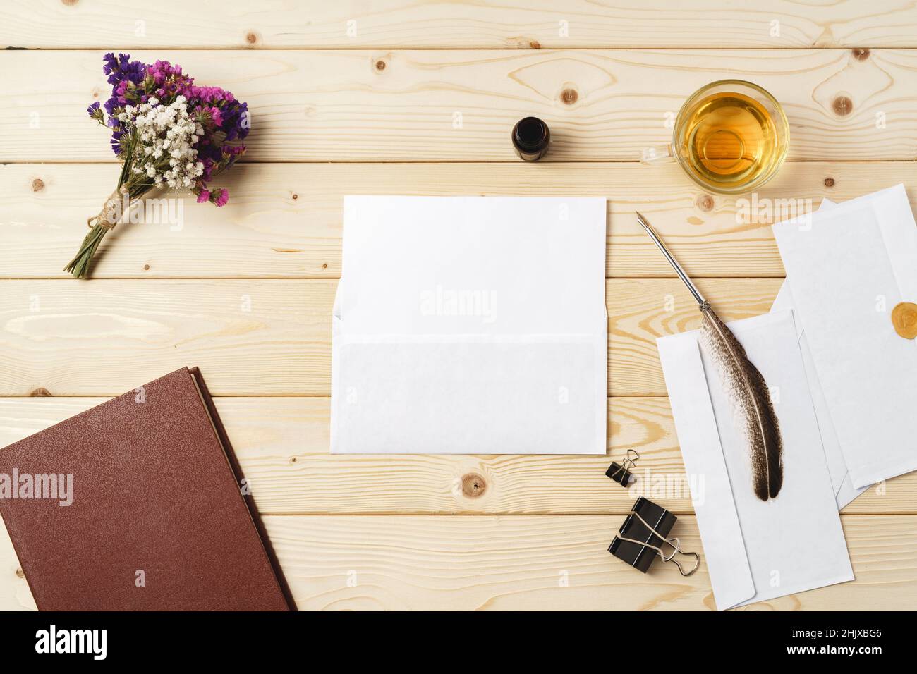 Flowers, blank paper and envelope on a table top Stock Photo - Alamy