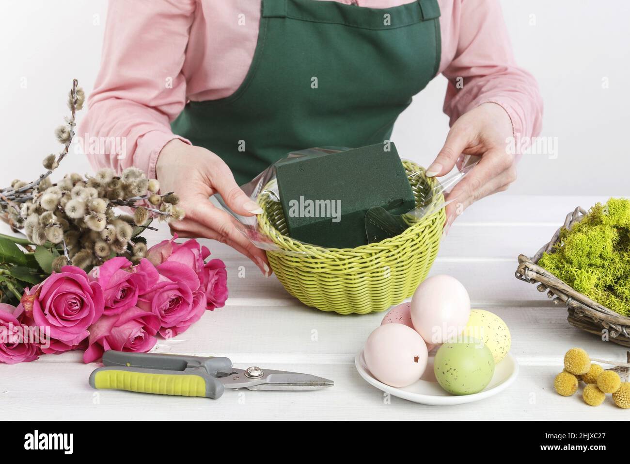 Florist at work: woman shows how to make Easter table decoration with ...