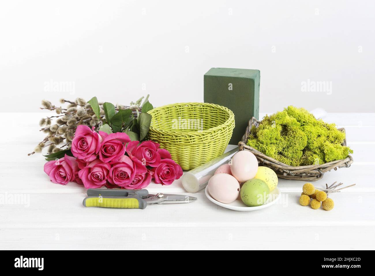 Florist at work: woman shows how to make Easter table decoration with ...