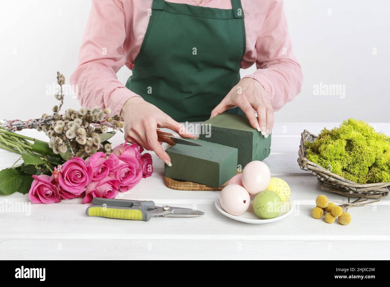 Florist at work: woman shows how to make Easter table decoration with ...
