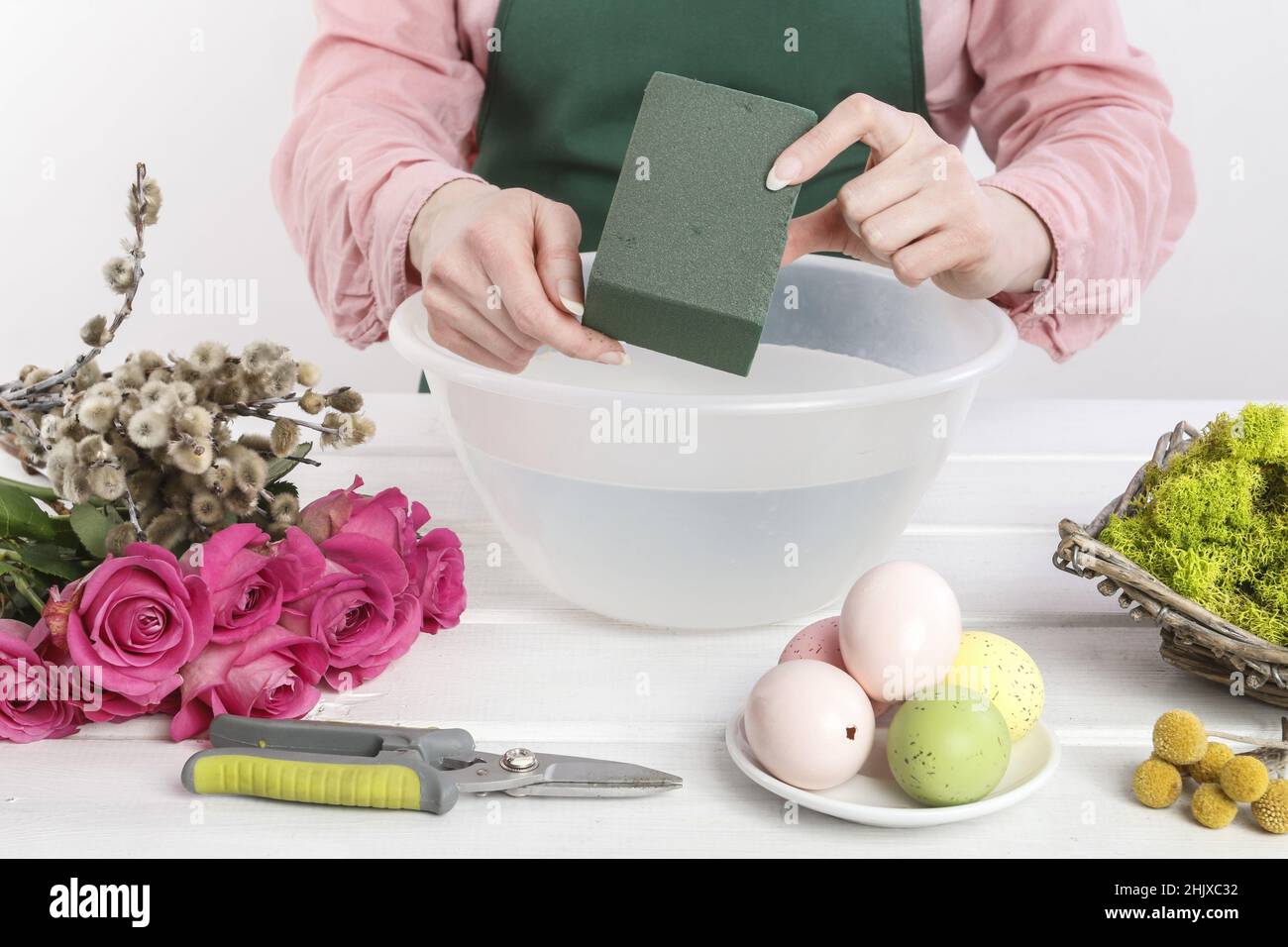 Florist at work: woman shows how to make Easter table decoration with ...